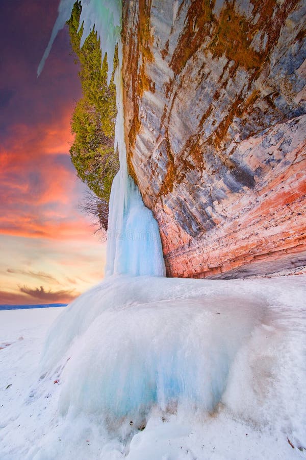 Winter Sunrise with Colorful Rock Cliffs Covered in Ice Formations ...