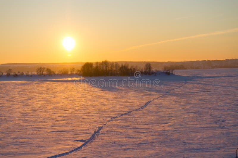 Winter sunset over field stock photo. Image of path - 150875580