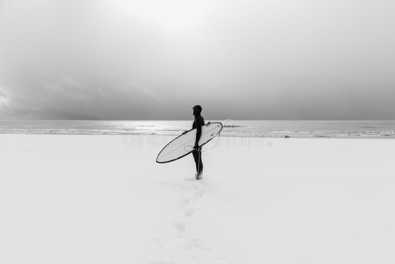 Winter and Surfer with Surfboard. Snow Beach and Surfer in Wetsuit ...