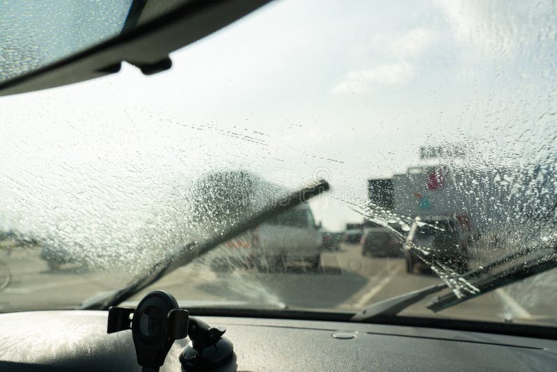 Wiper cleaning windshield stock photo. Image of windshield - 268020828