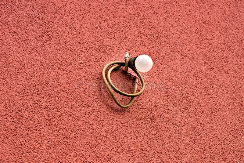 Wire light bulb on wall stock image. Image of electrical - 43414189
