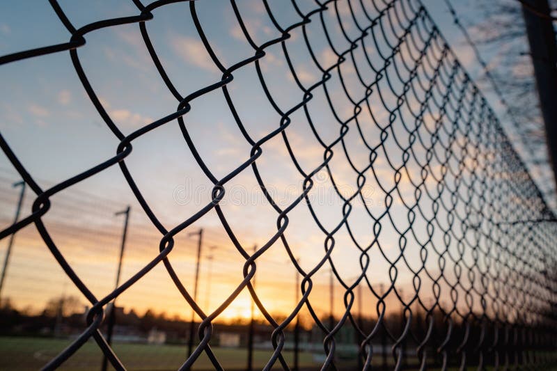 Wire Mesh Fence in Front of Sunset Sky Stock Photo - Image of landscape ...