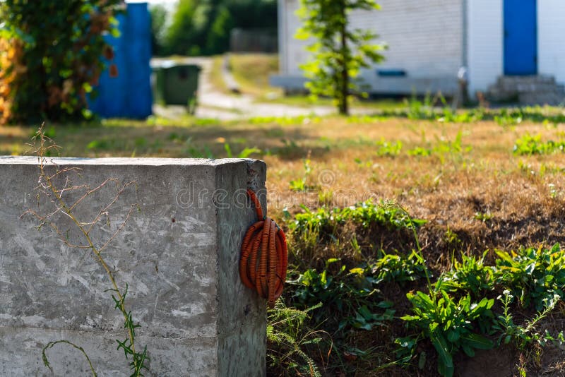 A Wire in an Old Orange-colored Protective Casing Sticks Out of the ...