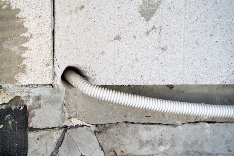 The Wire in a Protective Plastic Corrugated Pipe is Laid through the ...