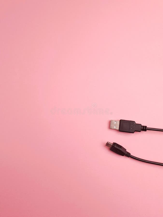 Wire with USB Connector and Mini USB on a Pink Background Close-up ...