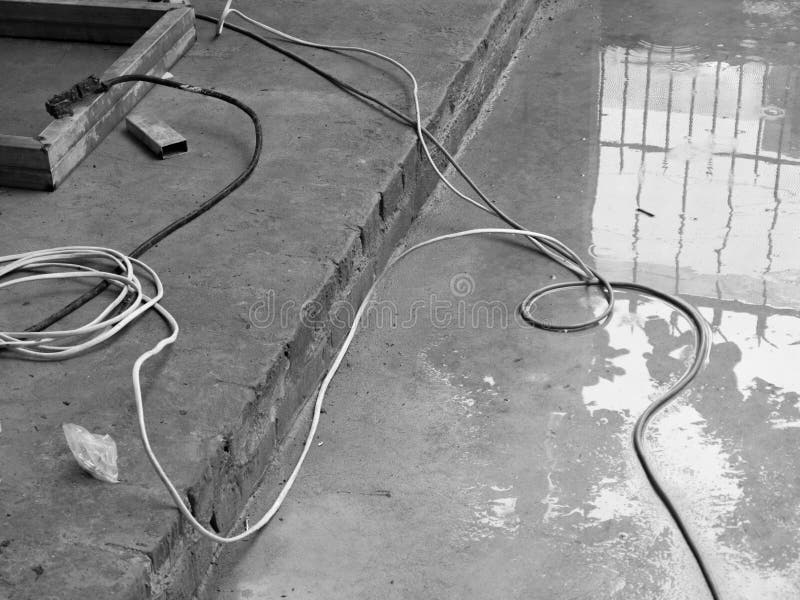 Wire on Wet Concrete Ground Stock Photo - Image of electricity, danger ...