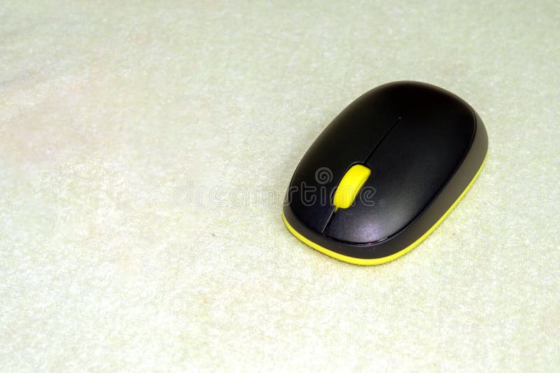 Wireless Black and Yellow Colored Computer Mouse on White Cloth Stock ...