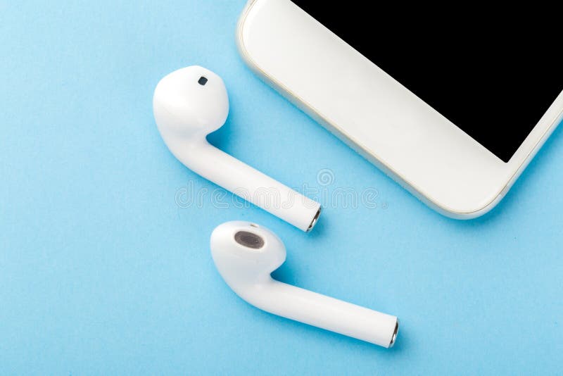 Wireless Bluetooth Headphones with a Modern Mobile Phone on a Blue ...