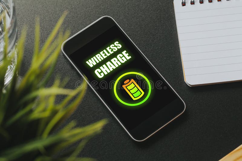 Wireless Charge in a Mobile Phone Screen Over a Black Business Table ...