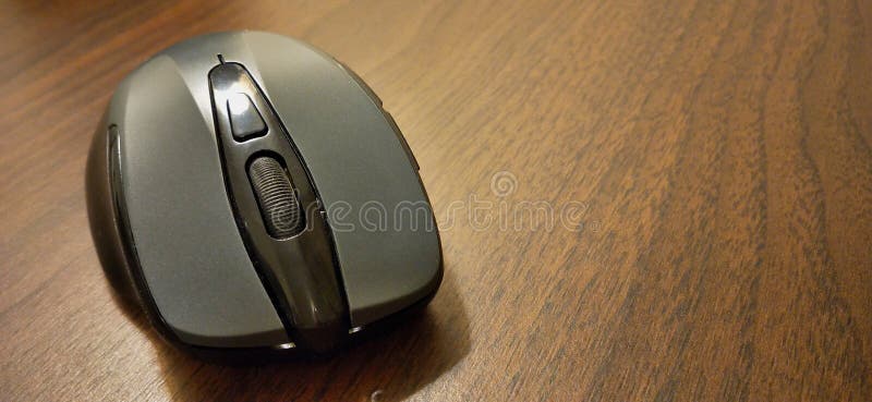 A Wireless Computer Mouse with Wood Surface Table Stock Photo - Image ...