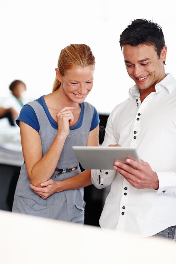 Wireless Fun in the Office. Two Coworkers Working on a Digital Tablet ...