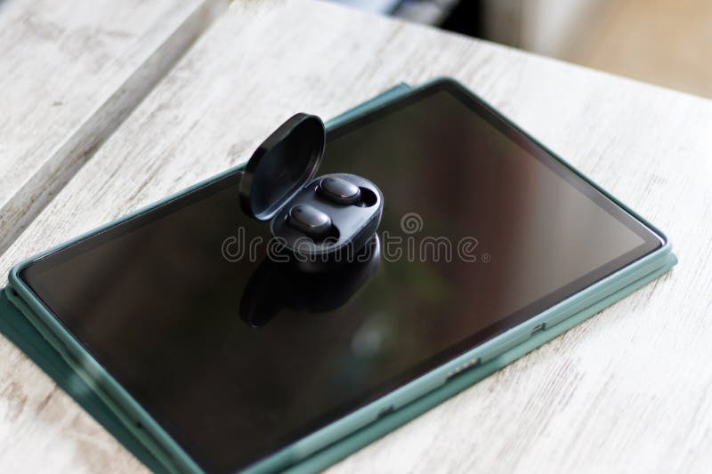 Wireless Headphones on a Tablet Stock Image - Image of earphones ...