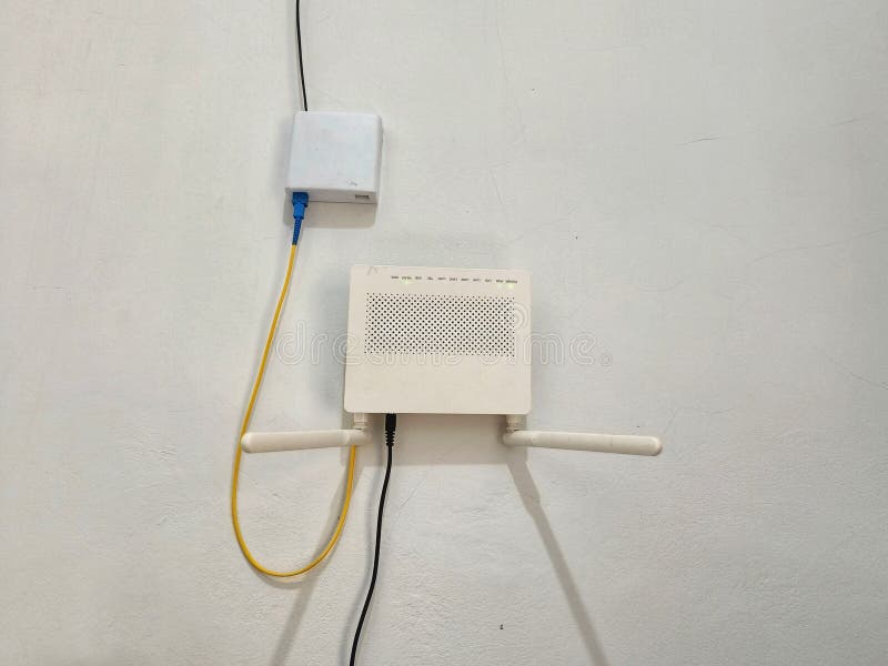 Wireless Router and Modem Setup on White Wall with Cables Stock Photo ...