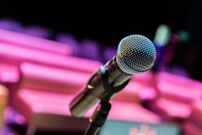 Wireless Microphone on Stand on Blurred Background. Empty Audience ...