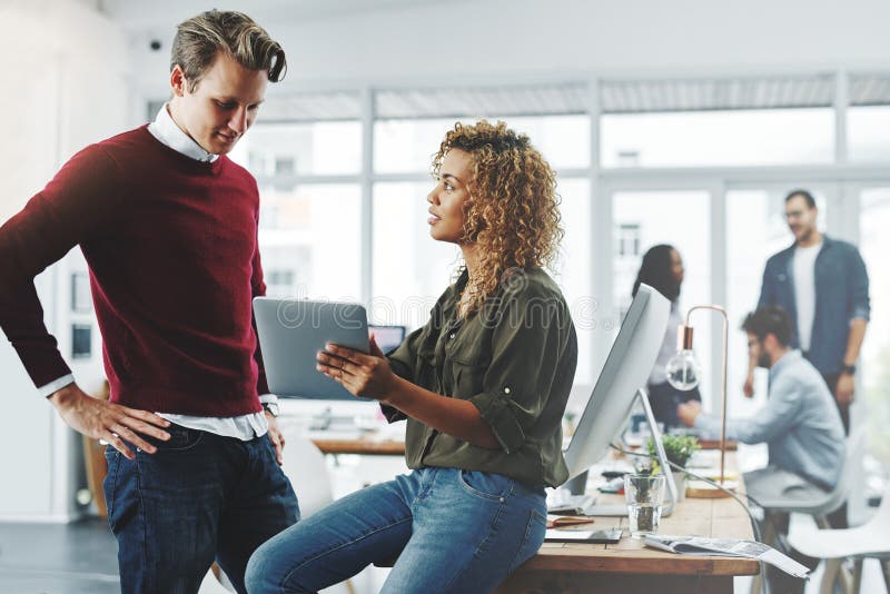 Wireless Tech Keeps Their Office Productive. Two Young Colleagues Using ...