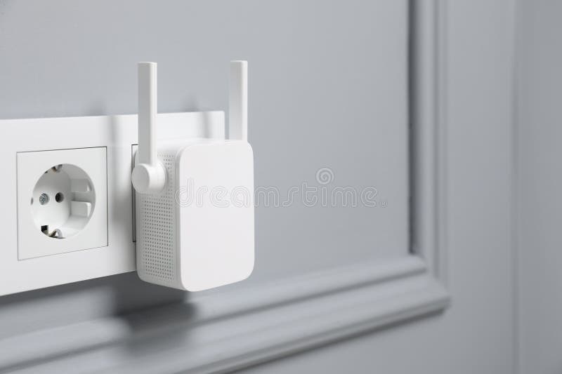 Wireless Wi-Fi Repeater on Light Grey Wall, Space for Text Stock Photo ...