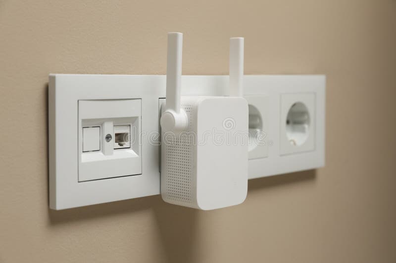 Wireless Wi-Fi Repeater in Power Socket on Beige Wall Stock Image ...
