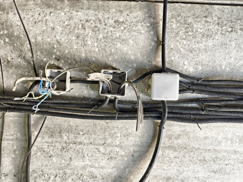 Wires and Cables Arranged Along a Concrete Wall in an Industrial ...