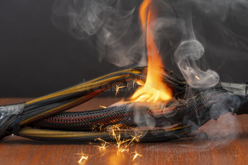 The Wiring is Burning and Sparking on a Dark Background. a Short ...