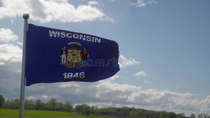Wisconsin Flag on a Flagpole Waving in the Wind, Blue Sky Background ...