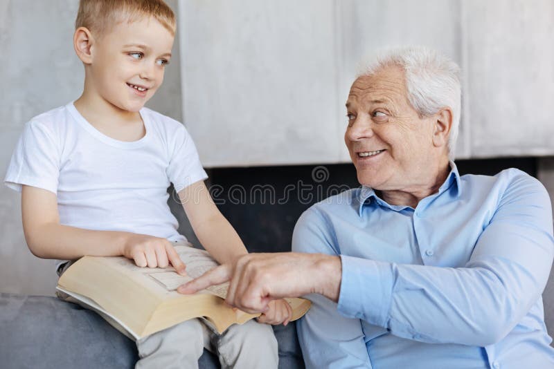 Wise Elderly Man Explaining Something To His Grandson Stock Photo ...