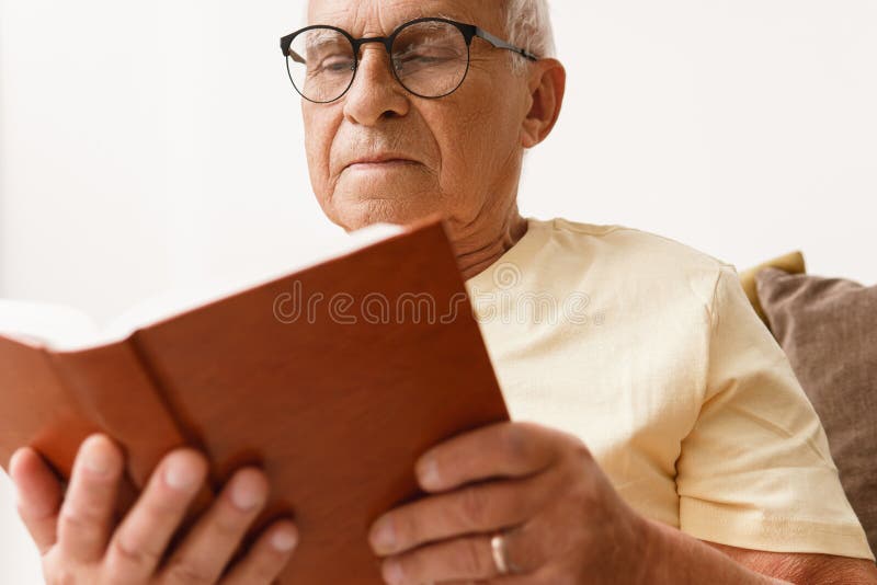 Wise and Elderly Man is Reading Book at Home Stock Image - Image of ...