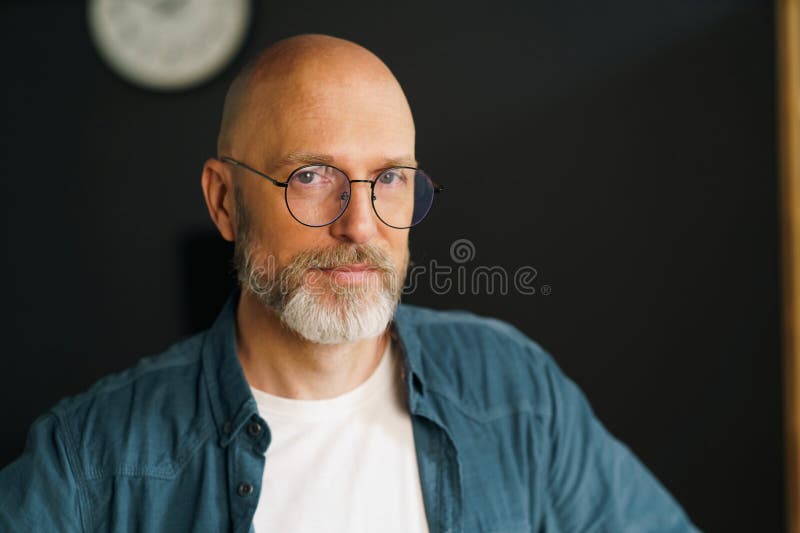 Wise Senior Worker with Silver Beard and Glasses Strikes Pose Against ...