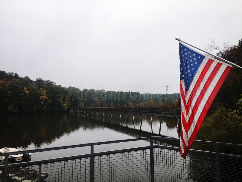 American Flag Over the Deck with the Bridge in the Background Stock ...