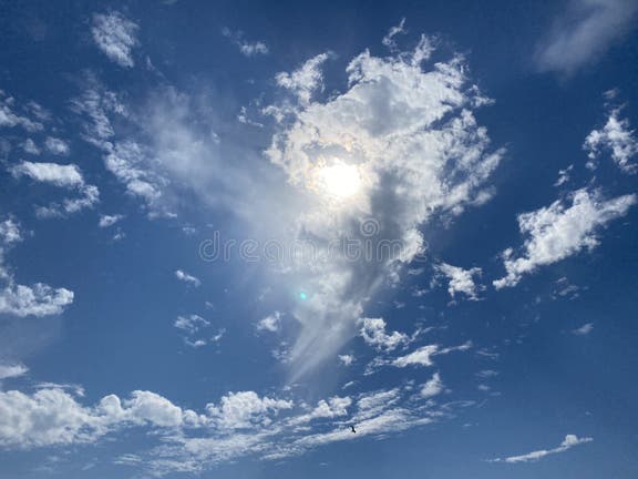 Wisp Cloud and White Light from Sun Stock Photo - Image of wind, ocean ...