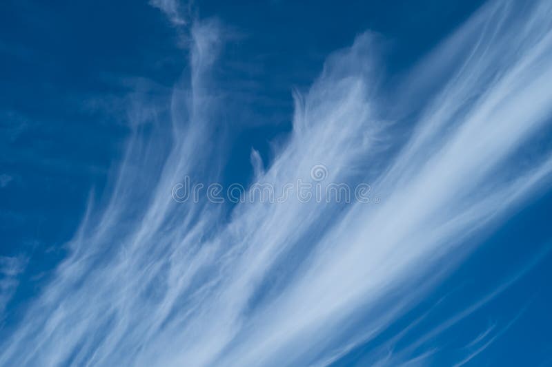 Wispy White Clouds Against a Bright Blue Sky Stock Image - Image of ...