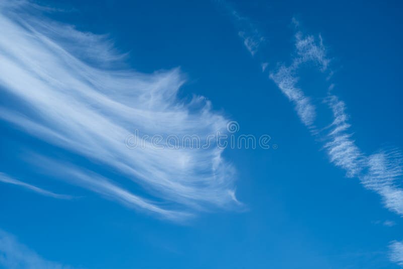 Wispy White Clouds Against a Bright Blue Sky Stock Photo - Image of ...