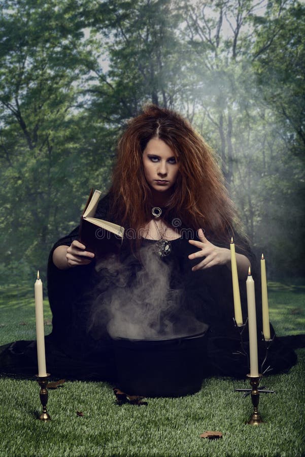 Witch with Cauldron and Spell Book in the Forest Stock Photo - Image of ...
