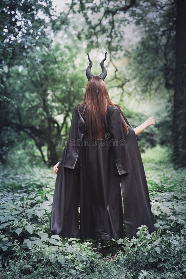 Witch with Horns Maleficent in the Forest, Back View Stock Image ...