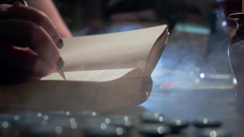 The Witch is Reading a Magic Book. Makes Notes of a Ritual Ceremony ...