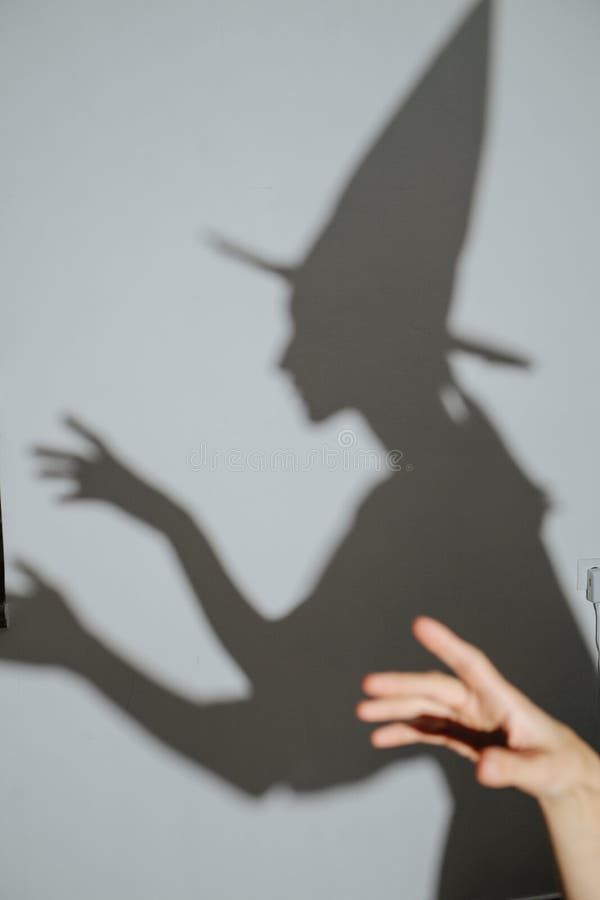 Witch Shadow on the Wall and a Hand of a Person Casting it in ...