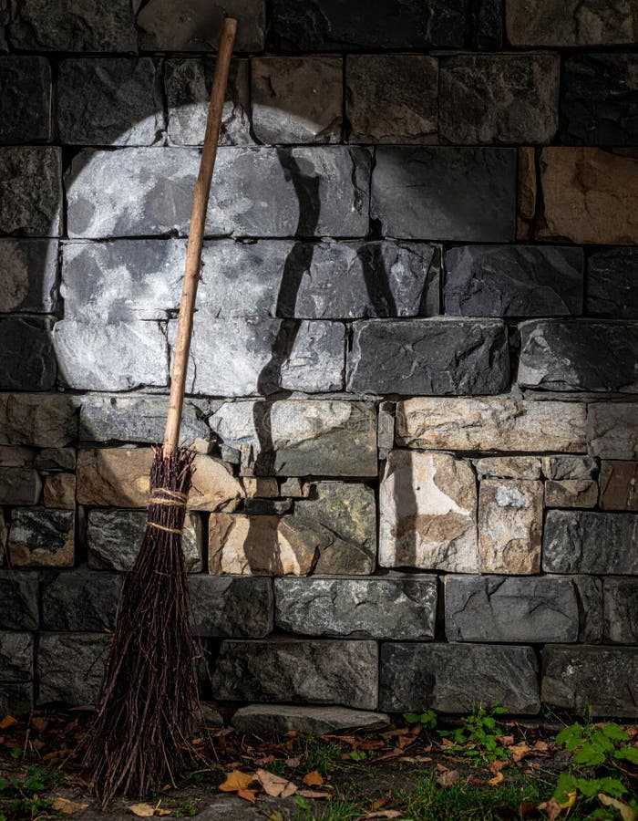 Witches Broom Leaning Against Stone Wall with a Spotlight Casting Moon ...