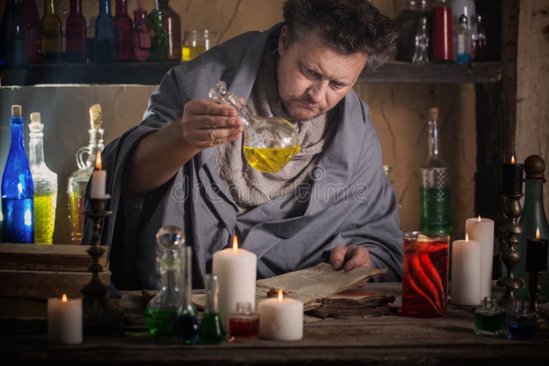Wizard brews a potion stock photo. Image of magician - 84096942