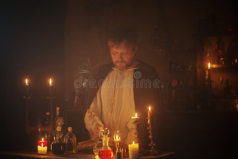 Wizard with Burning Candles and Magic Potions Stock Photo - Image of ...