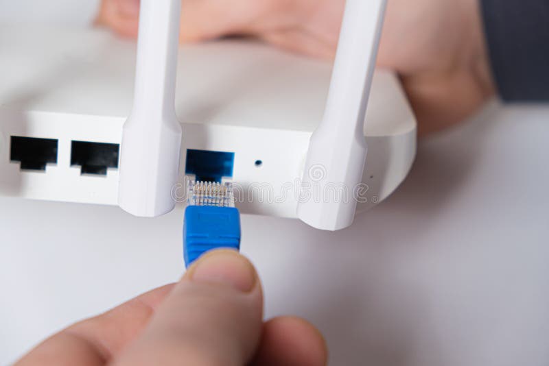 The Wizard Inserts the Internet Cable into the Wi-Fi Router. Internet ...