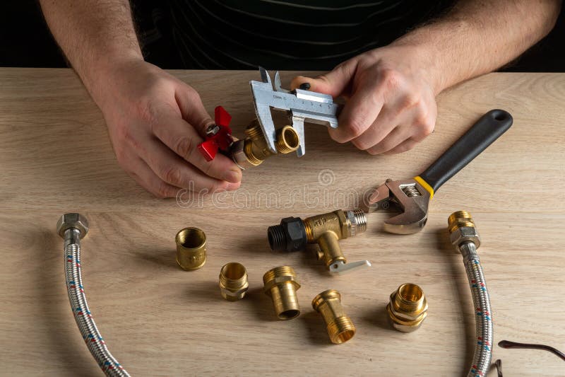 The Wizard Measures the Size of Fitting Using a Caliper before ...