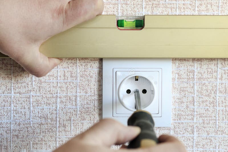 . the Wizard Using the Level Set the Outlet. he is White. Close-up ...