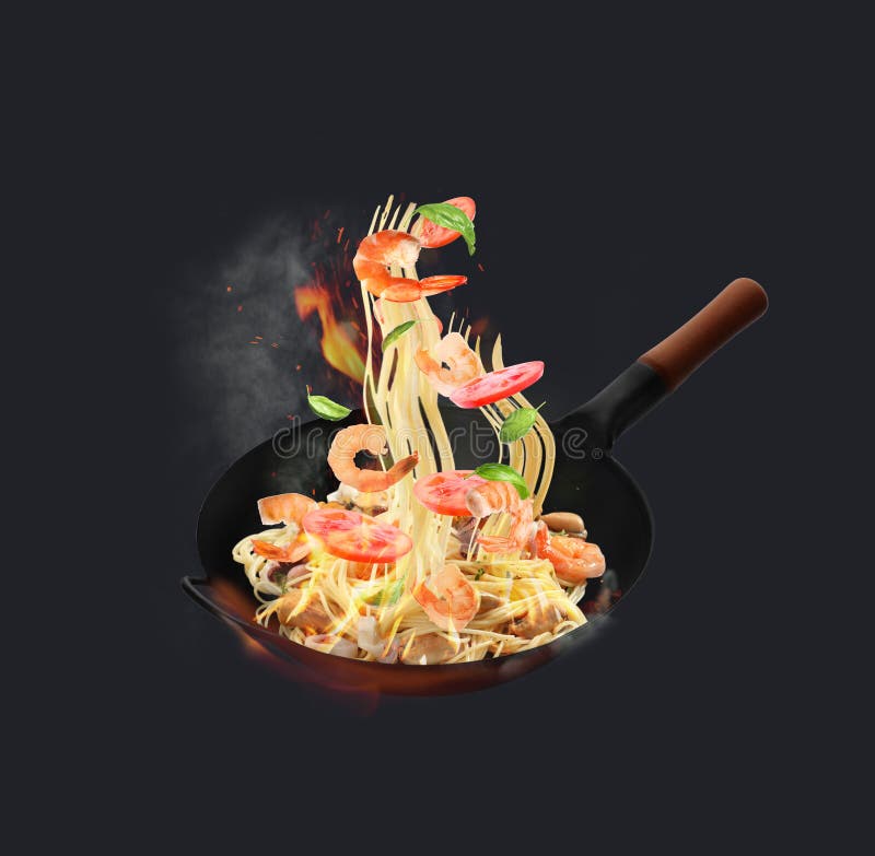 Wok with Tasty Ingredients and Fire on Dark Background Stock Photo ...