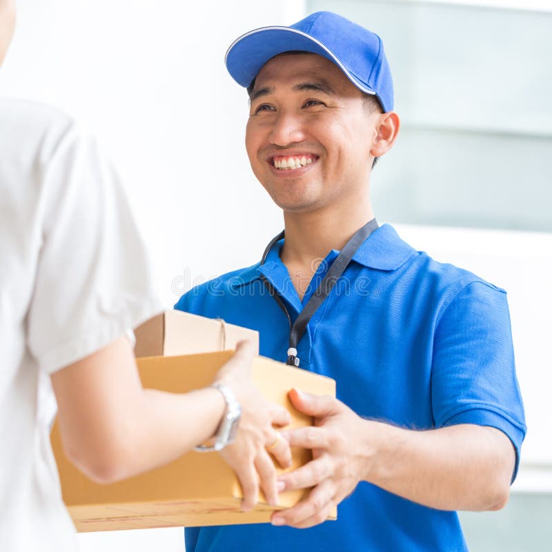 Woman Accepting a Delivery of Cardboard Boxes from Deliveryman Stock ...