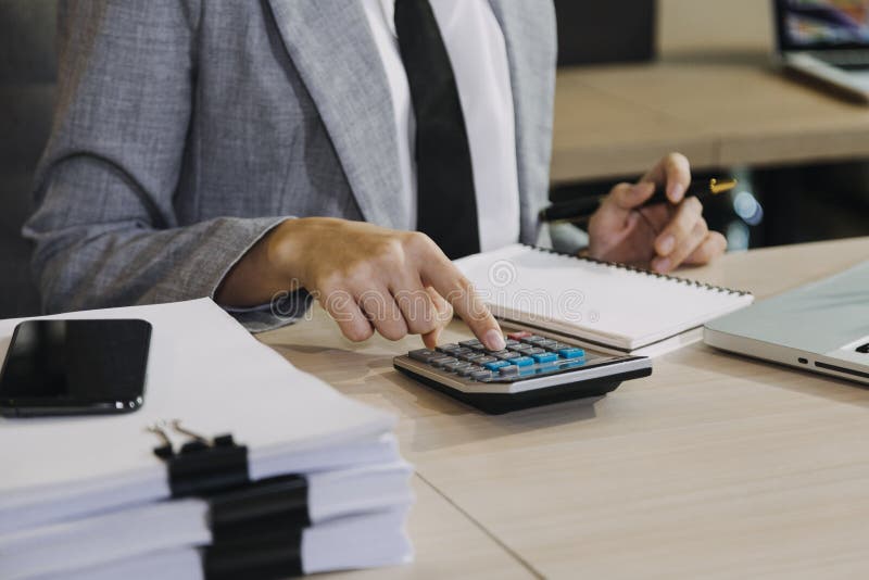 Woman Accountant Use Calculator and Computer with Holding Pen on Stock ...