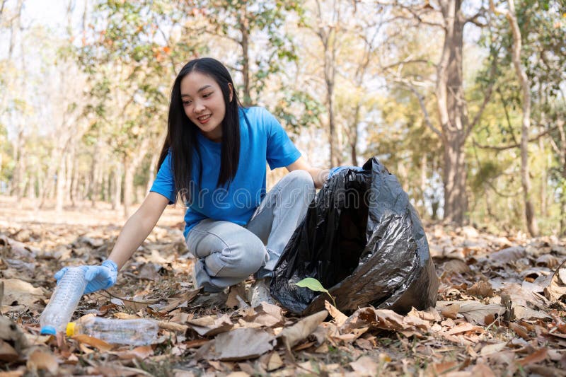 Woman Picking Litter with Bag in Leafy Forest Stock Image - Image of ...