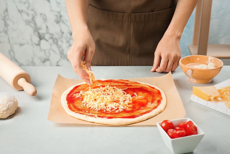 Woman Adding Cheese To Pizza Stock Photo - Image of adding, culinary ...