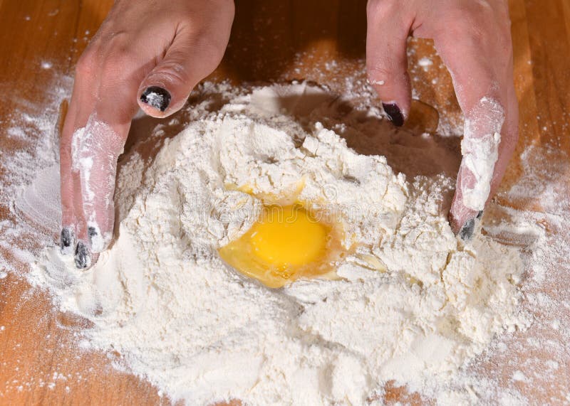 Woman Adding Egg To the Flour Stock Image - Image of ingredient, chef ...