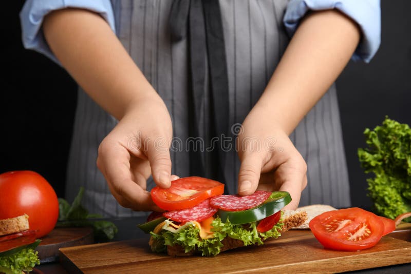 Woman Adding Tomato To Sandwich at Table Stock Image - Image of healthy ...