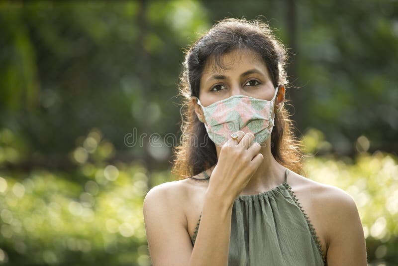 Woman Adjusting Protective Face Mask at Park Stock Image - Image of ...