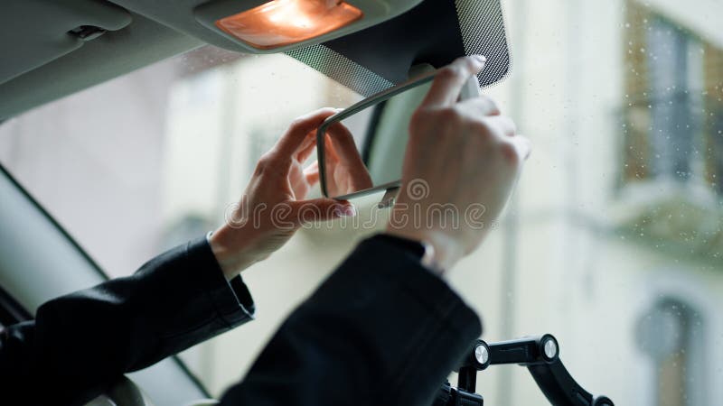 Woman Adjusting the Rear Mirror Stock Photo - Image of inside, mirror ...